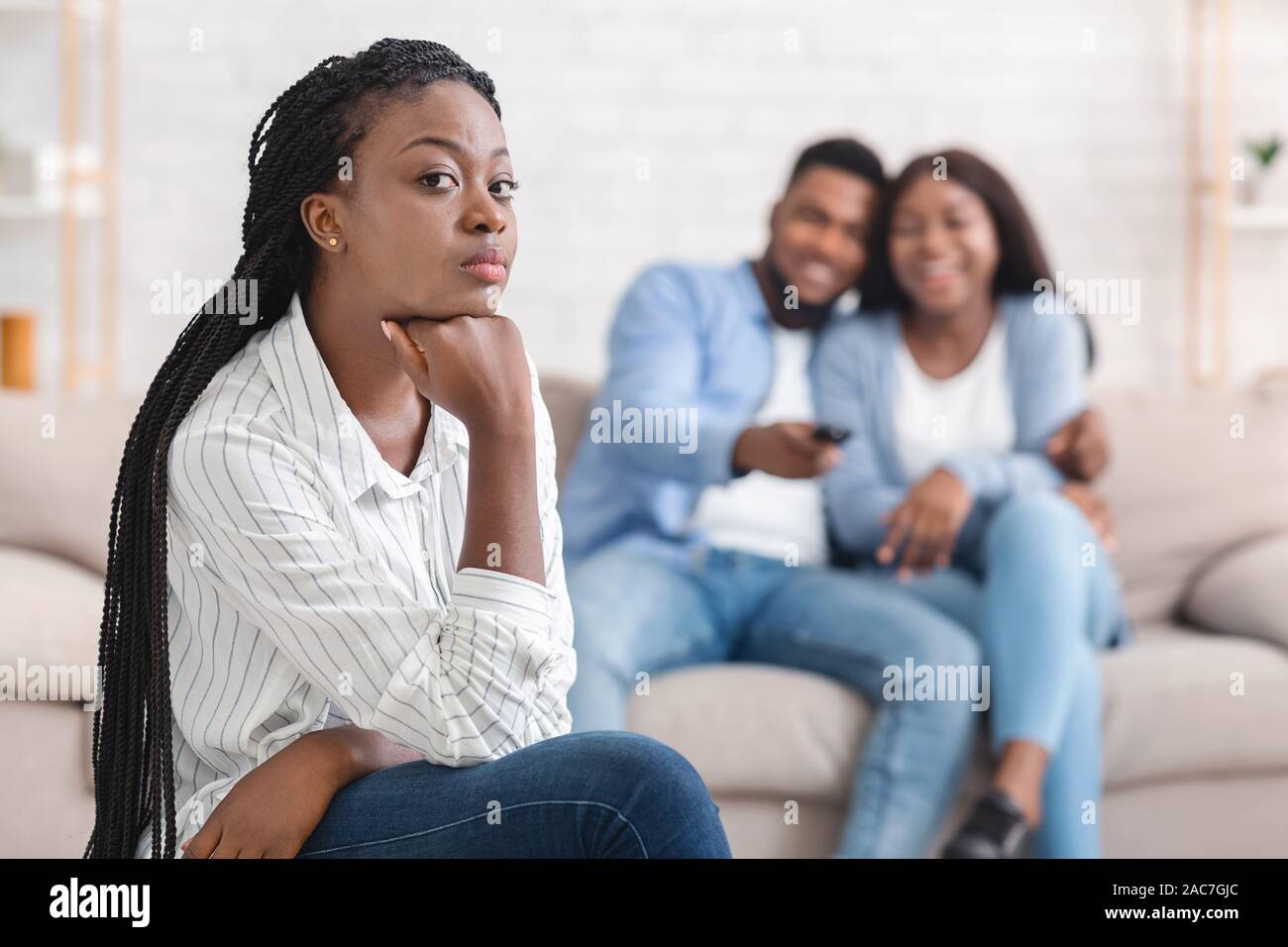 Envy Girl Sitting Alone While Her Dating Friends Hugging On Couch Stock ...