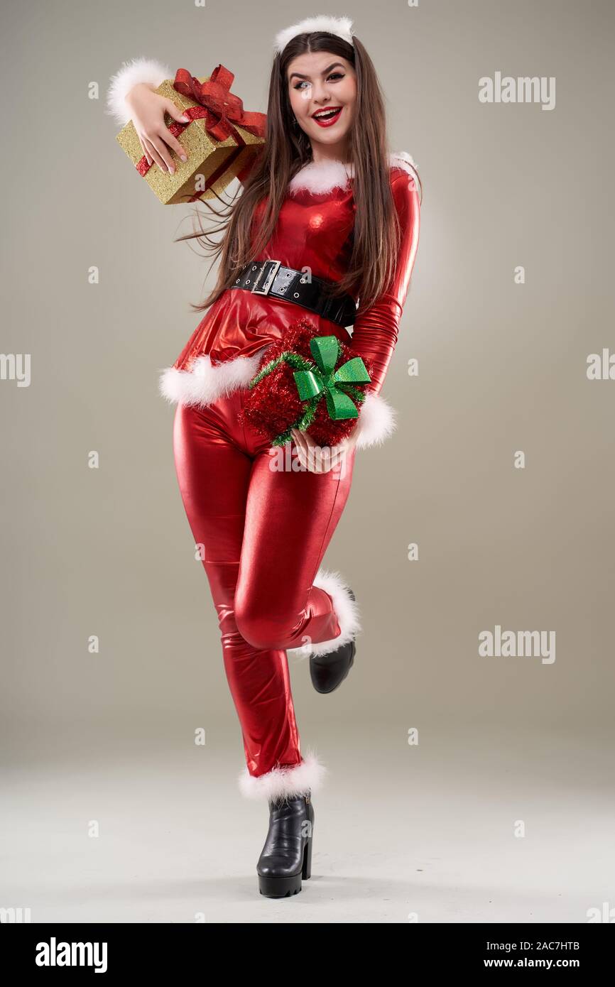 Full length of a Santa girl bearing presents Stock Photo - Alamy