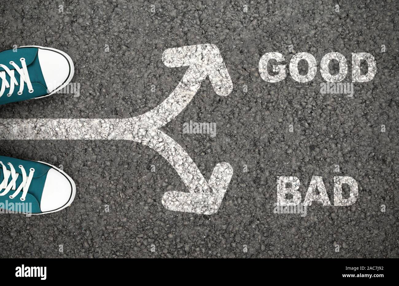 Good and bad written on alphalt road Stock Photo - Alamy