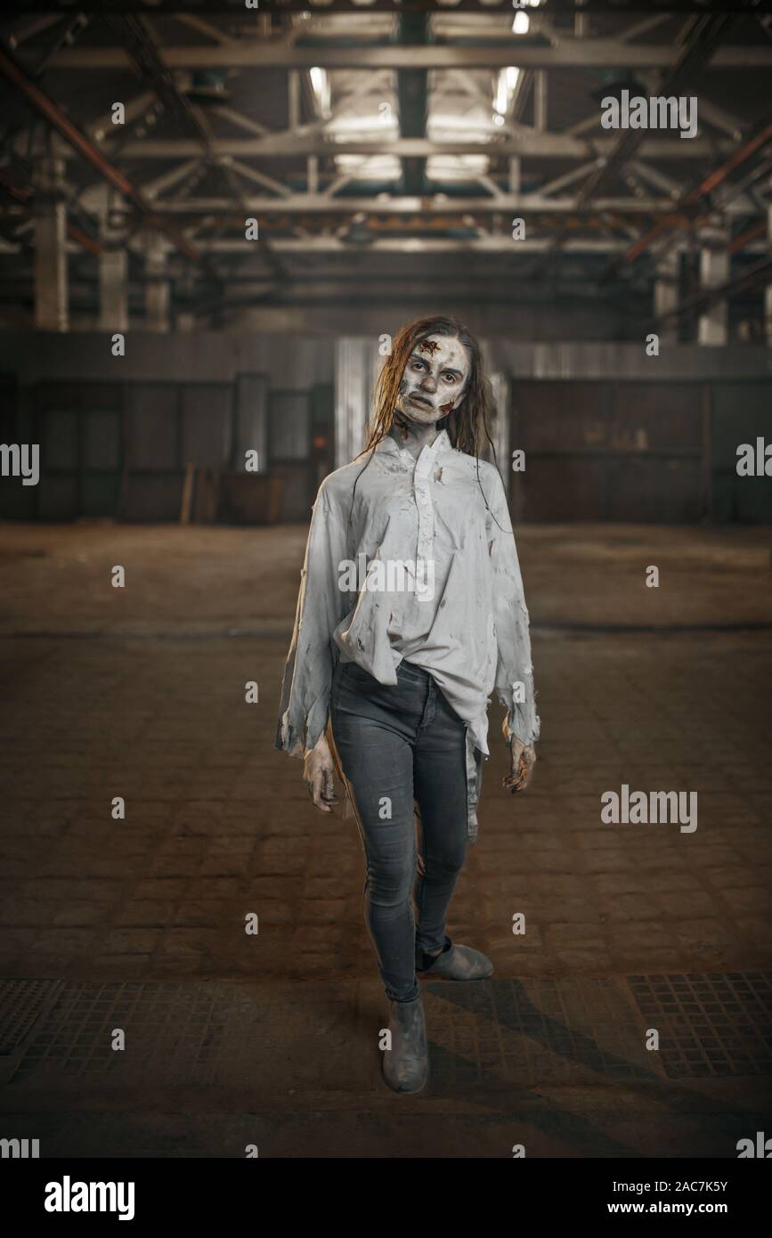 Female zombie walking in abandoned factory, horror Stock Photo - Alamy