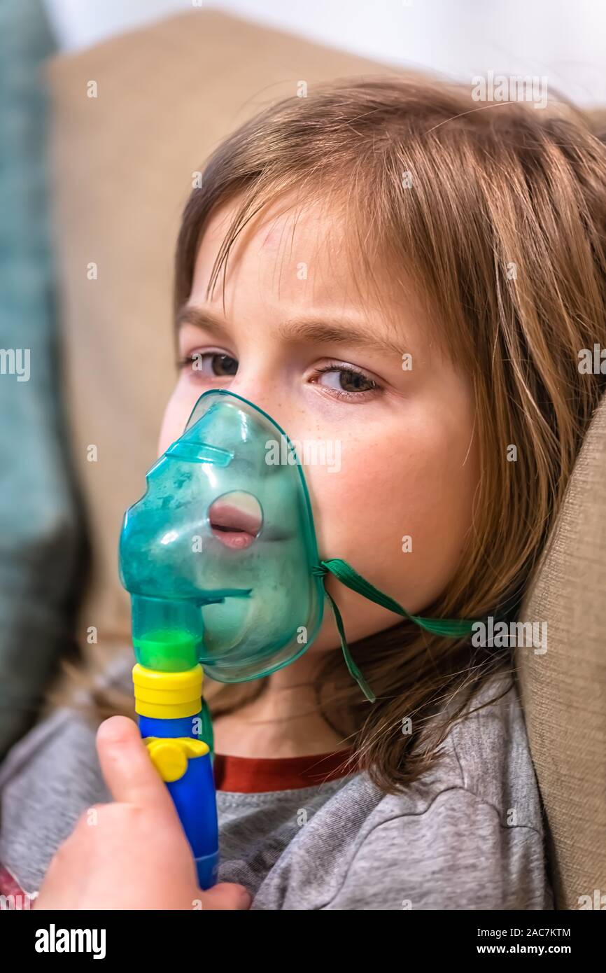 Cute baby girl breathes through nebulizer inhaler Stock Photo - Alamy