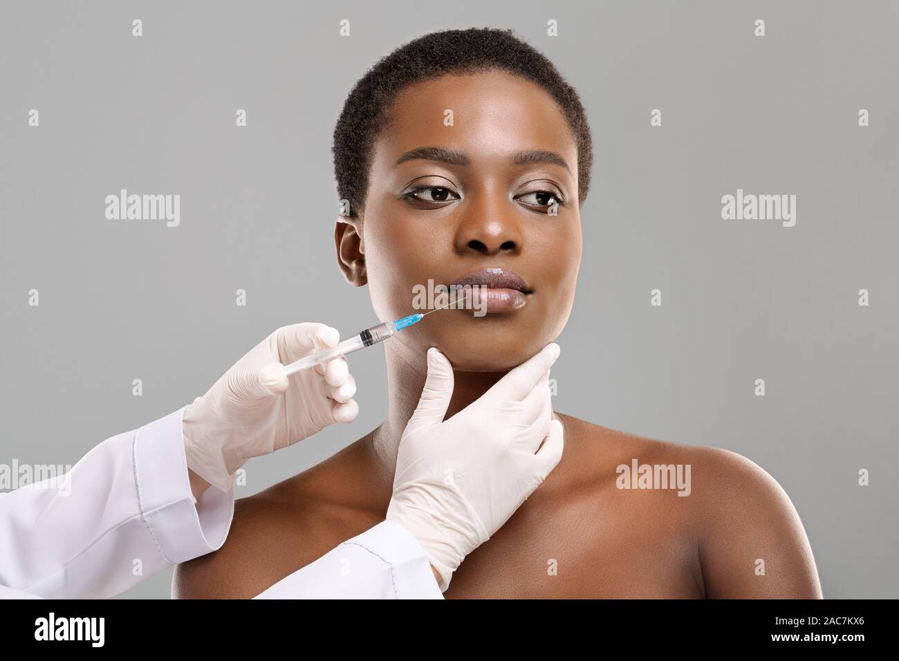 African american woman making lip augmentation procedure by doctor ...