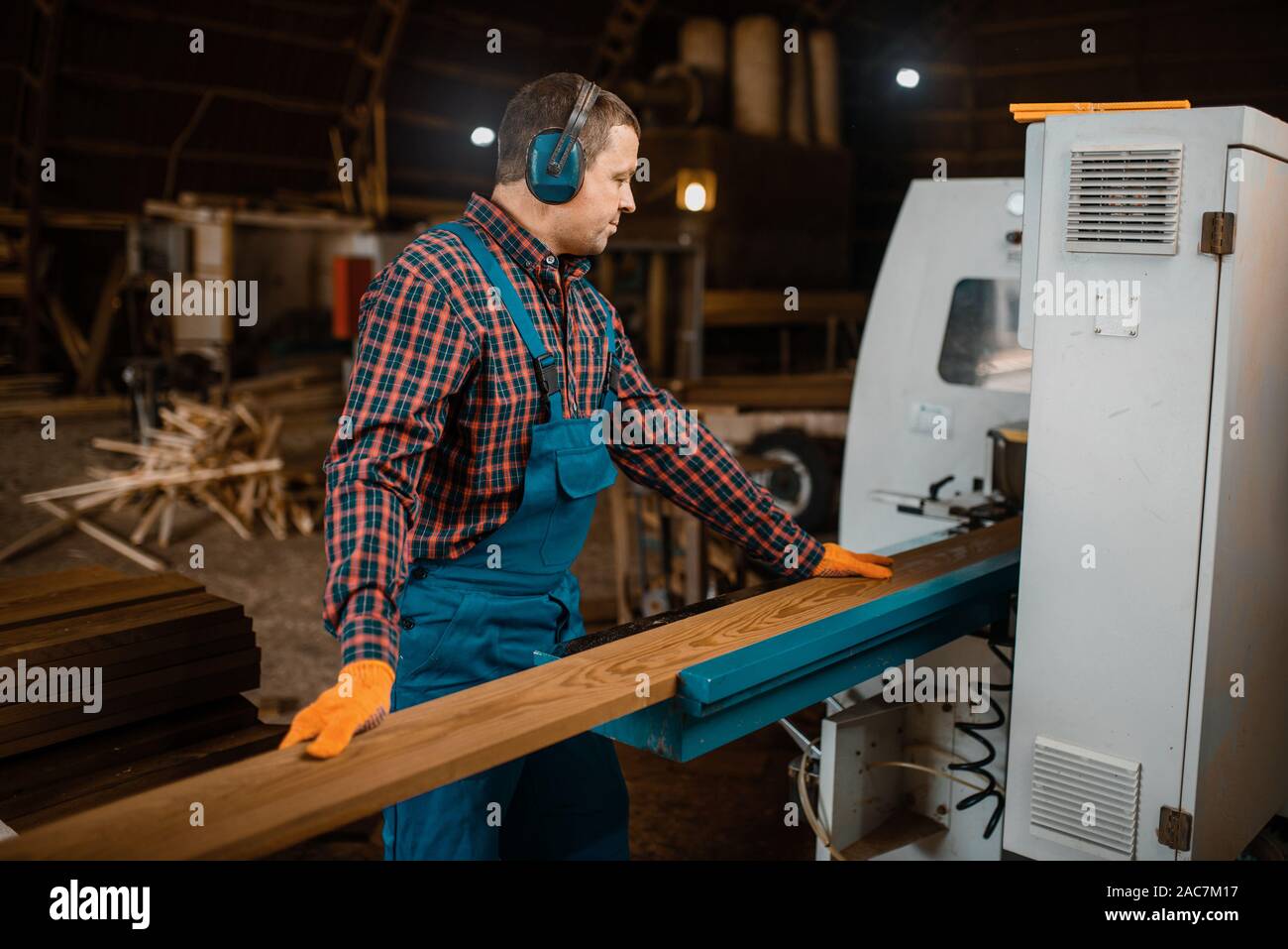 Woodworker works on machine, lumber industry Stock Photo - Alamy