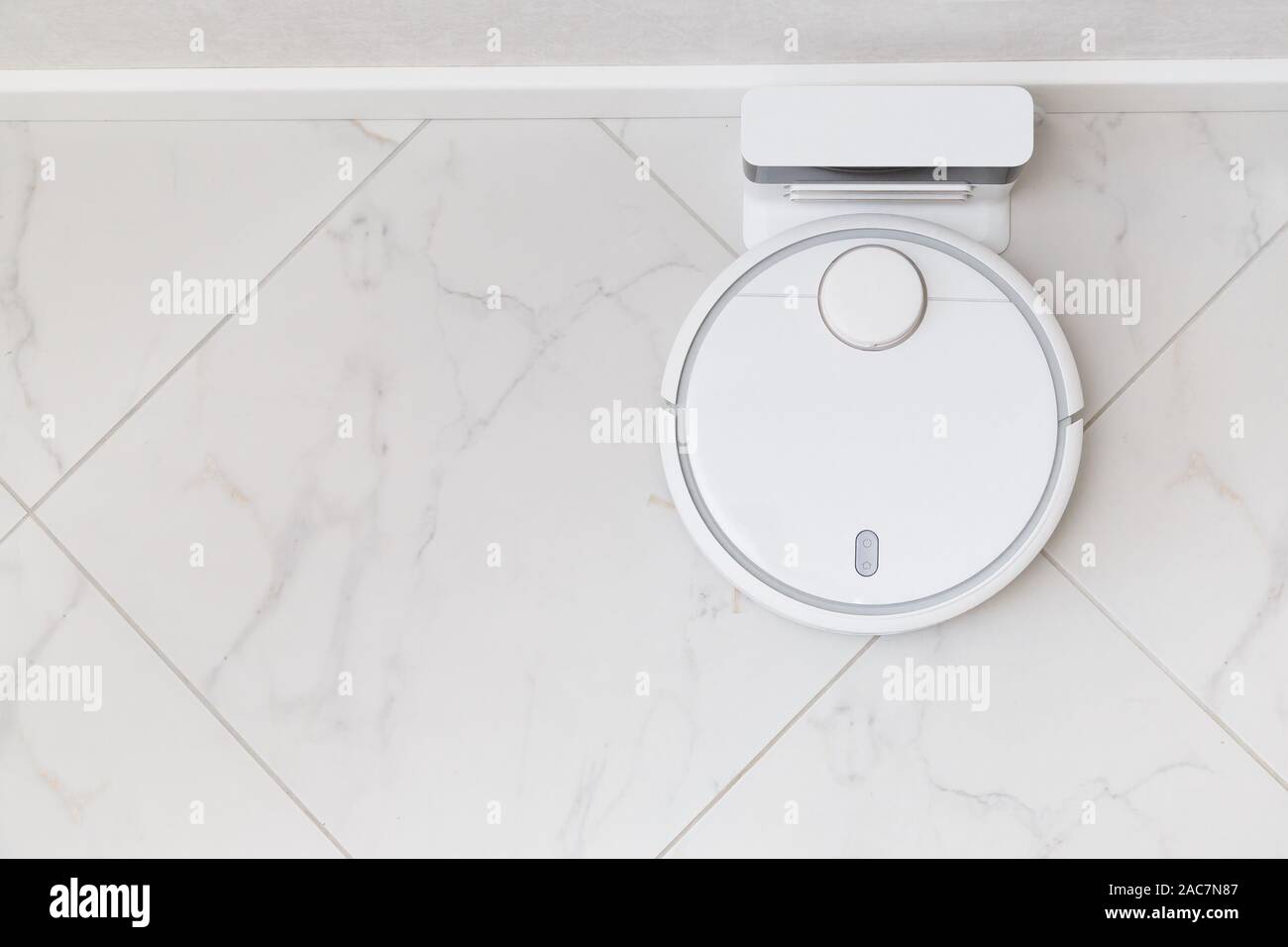 Robot vacuum cleaner on charging in room. Top view Stock Photo - Alamy