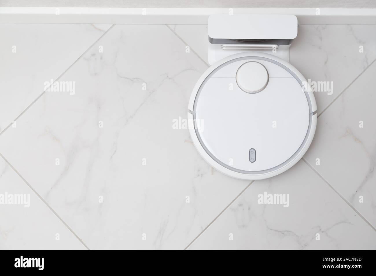 Robot vacuum cleaner on charging in room. Top view Stock Photo - Alamy