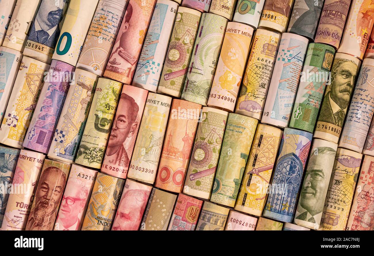 Different colourful banknotes from various countries on rolls to be ...