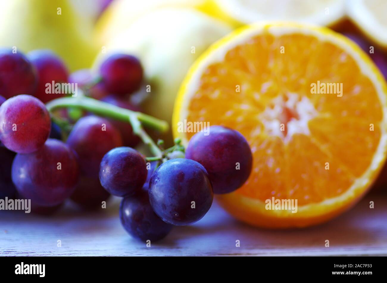 grapes and slices of orange fruit Stock Photo - Alamy