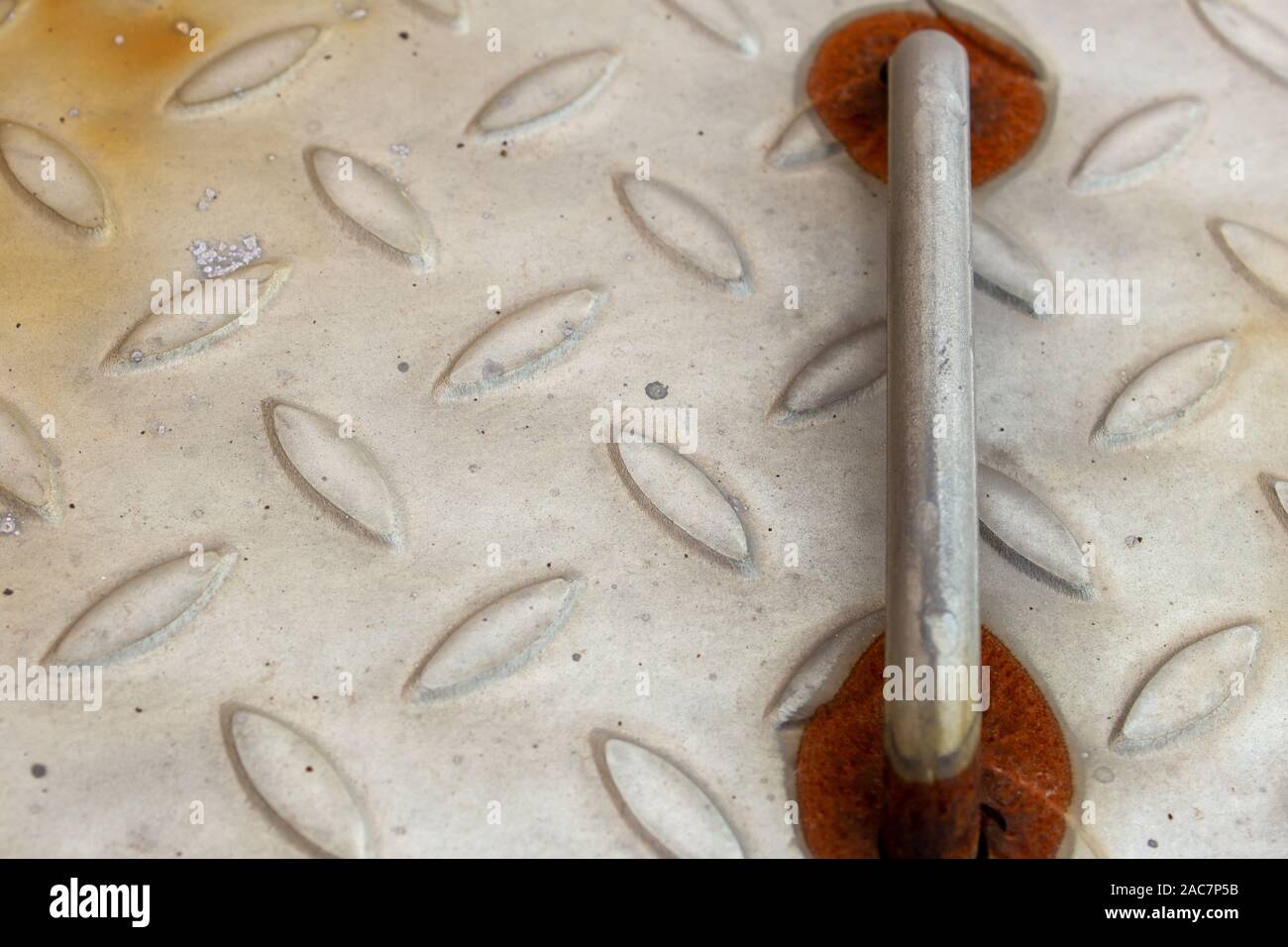 Metal sheet with handle having gray diamond shaped texture, background ...