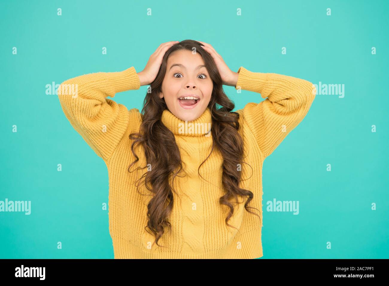 Adorable surprised girl wear yellow sweater turquoise background ...