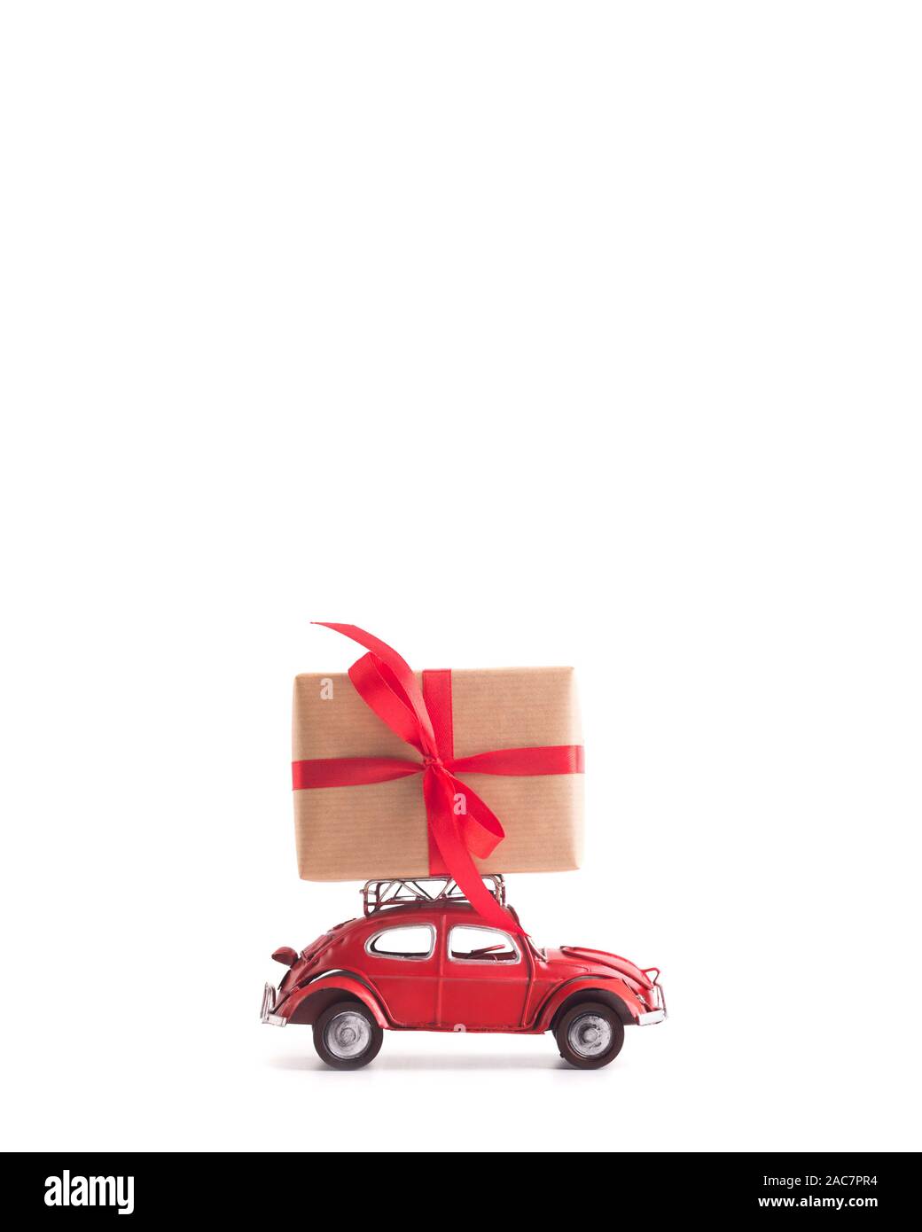 Red toy car Volkswagen Beetle with creative wrapped box on white ...