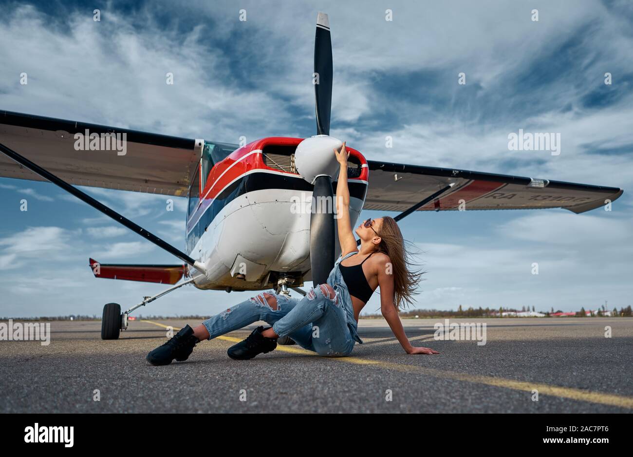 beautiful girl on the runway at the plane Stock Photo - Alamy