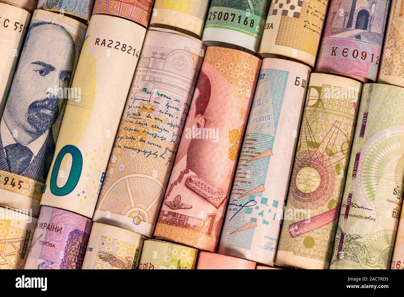 Different colourful banknotes from various countries on rolls to be ...