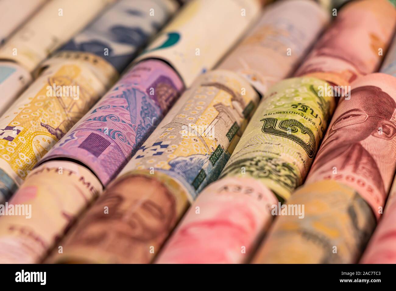Different colourful banknotes from various countries on rolls to be ...