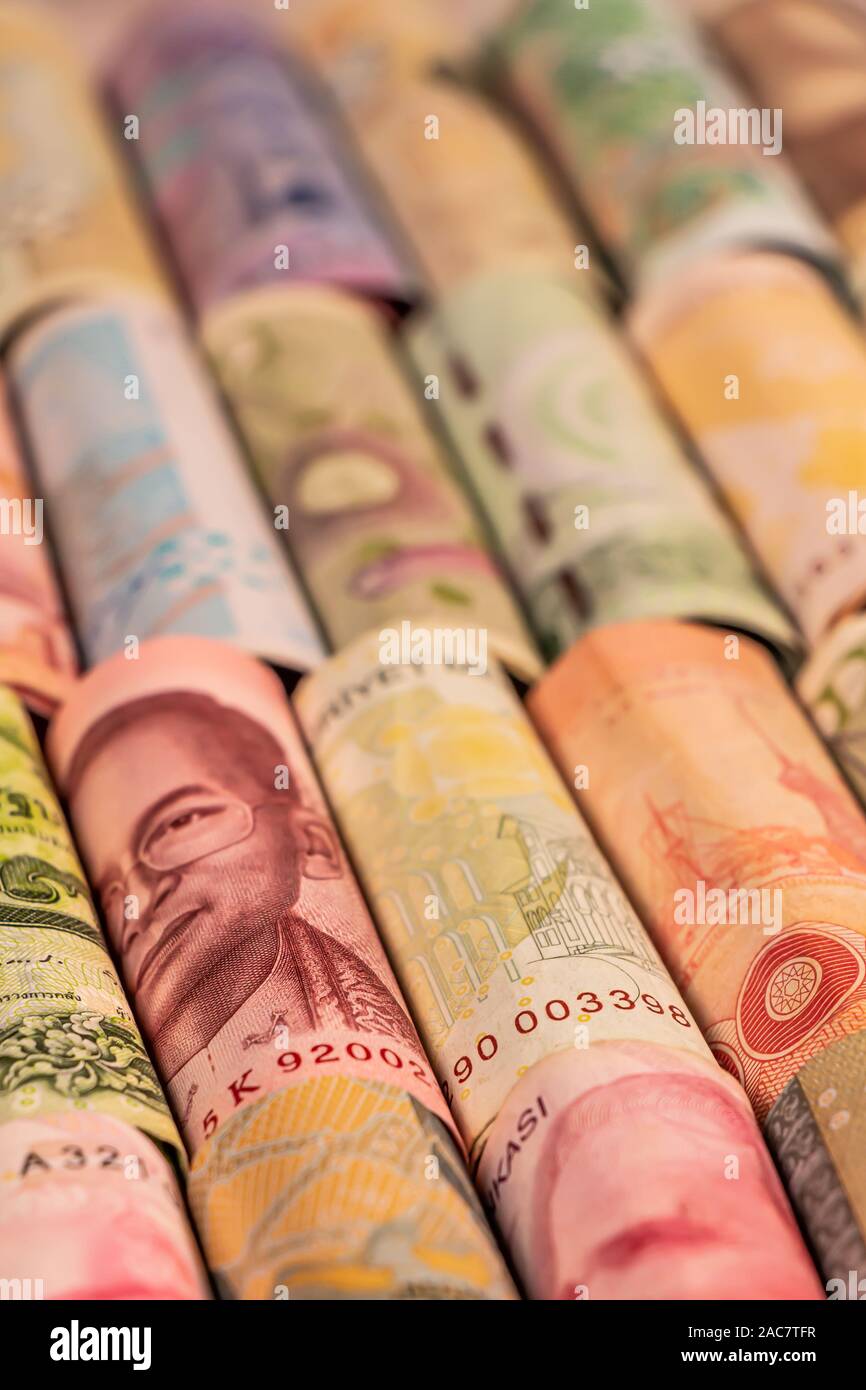 Different colourful banknotes from various countries on rolls to be ...
