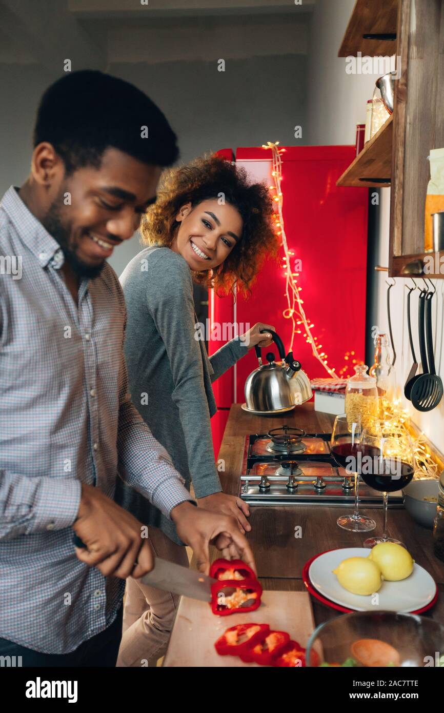 Happy african-american couple cooking dinner in kitchen Stock Photo - Alamy
