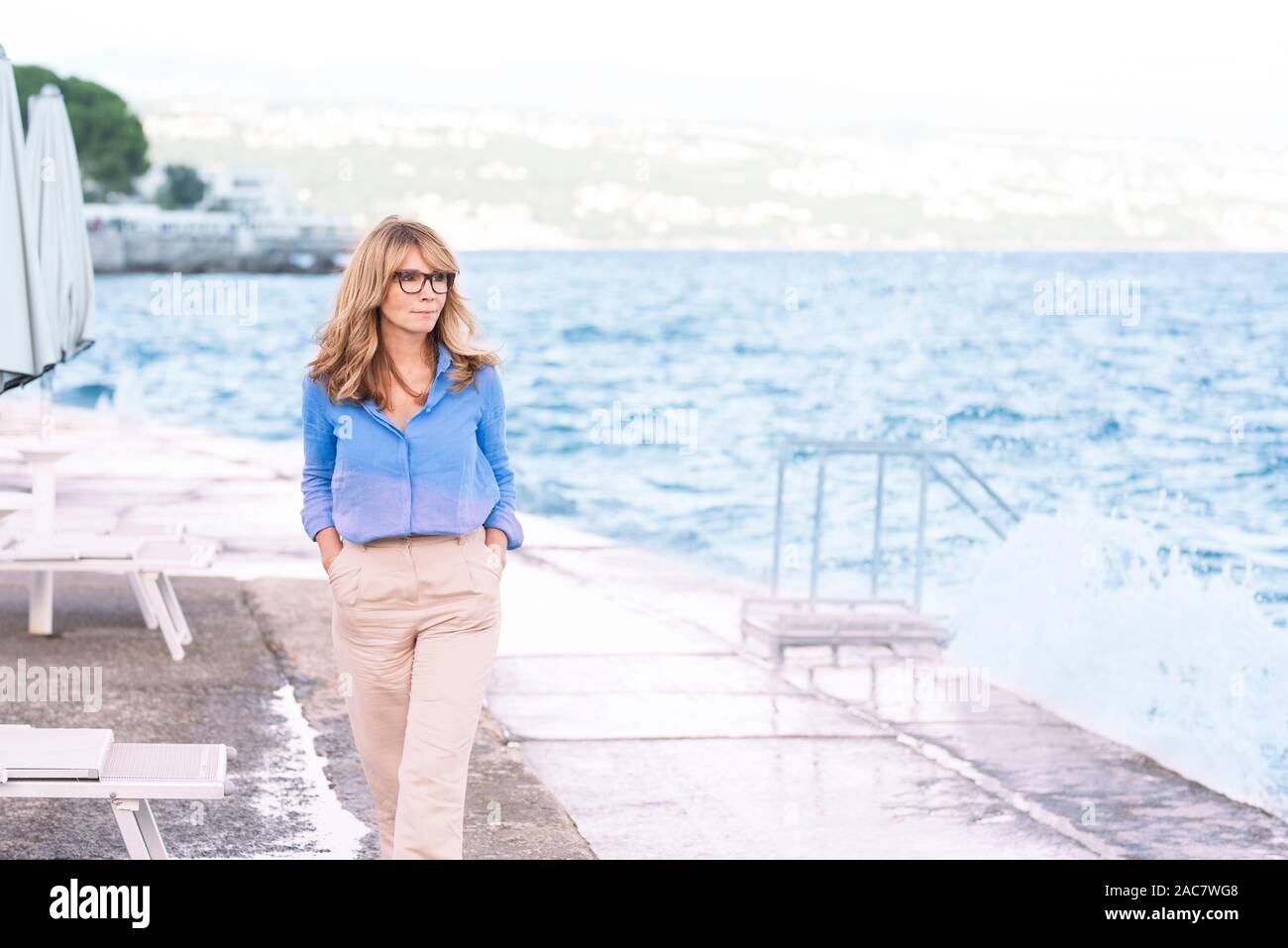 Shot of attractive middle aged woman walking on the beach Stock Photo ...