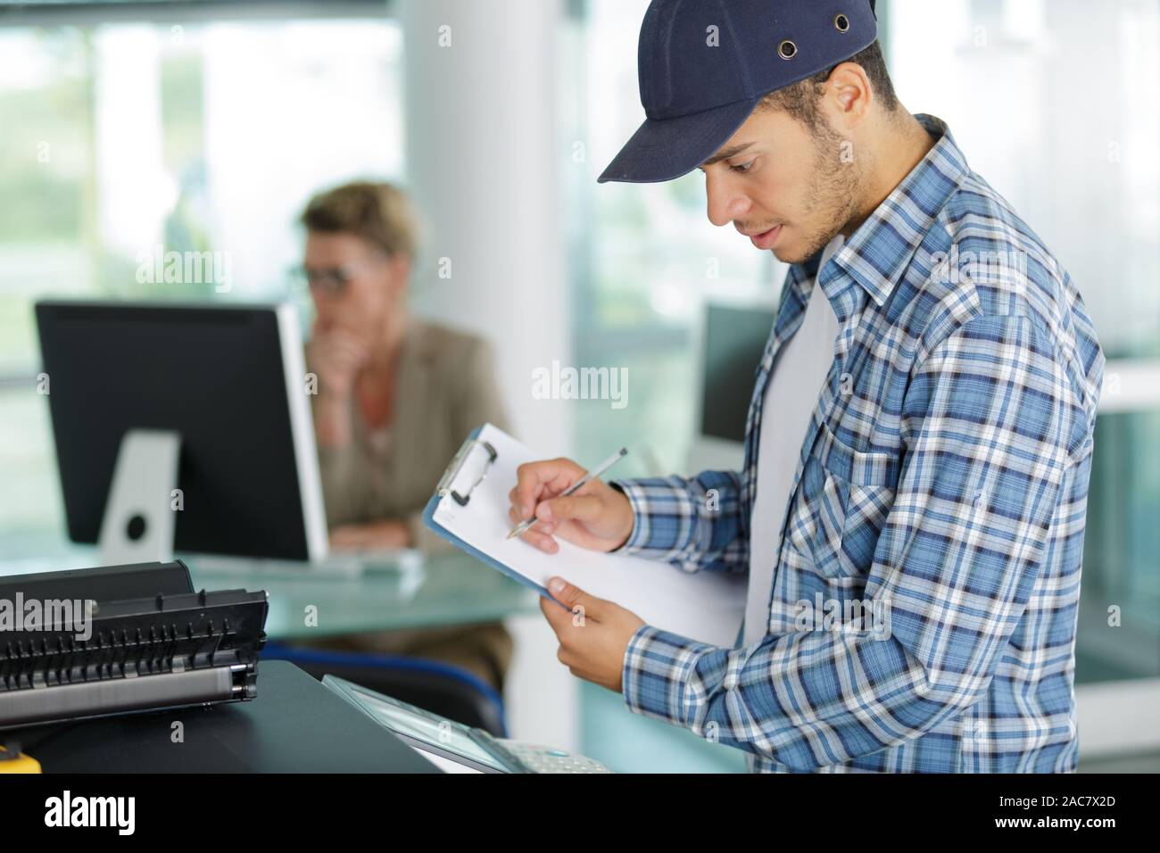 maintenance man checks a printer at work Stock Photo - Alamy