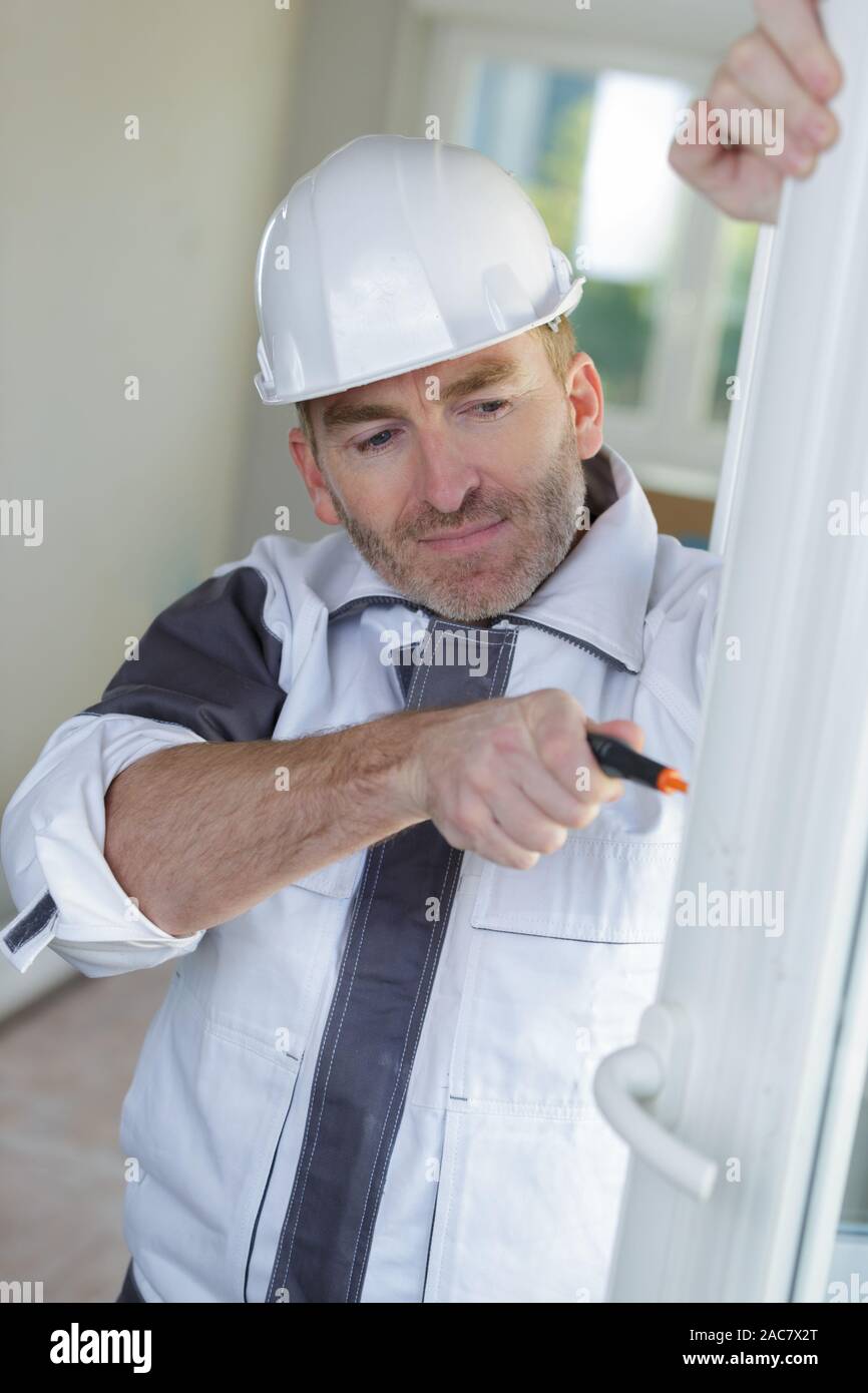 Young man fixing door hi-res stock photography and images - Alamy