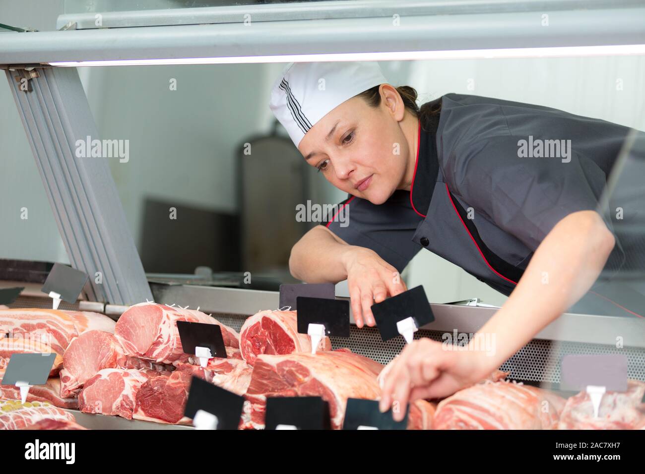 woman pork butcher cutting cooked ham with machine Stock Photo - Alamy