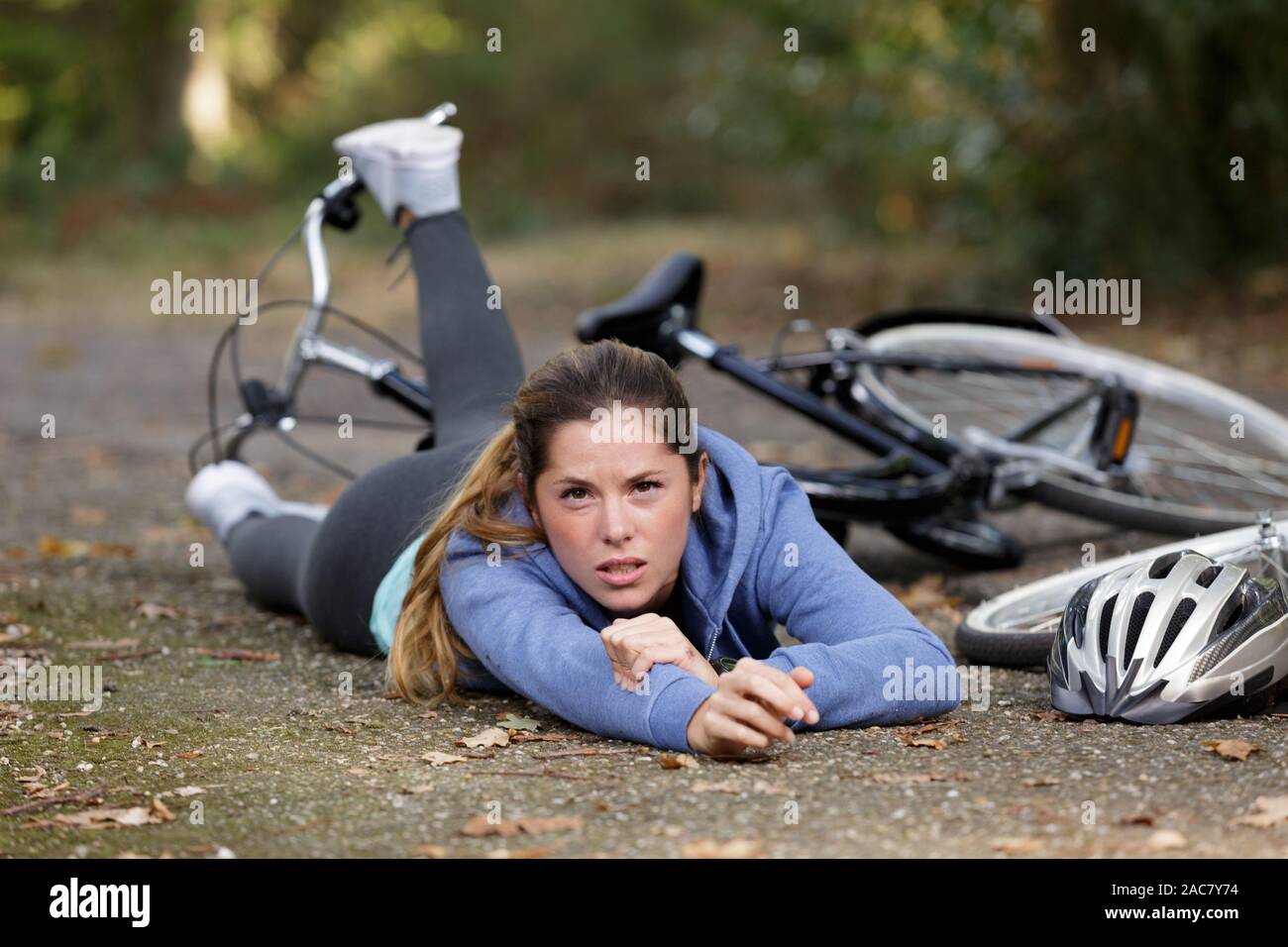 woman fell off a bicycle Stock Photo - Alamy