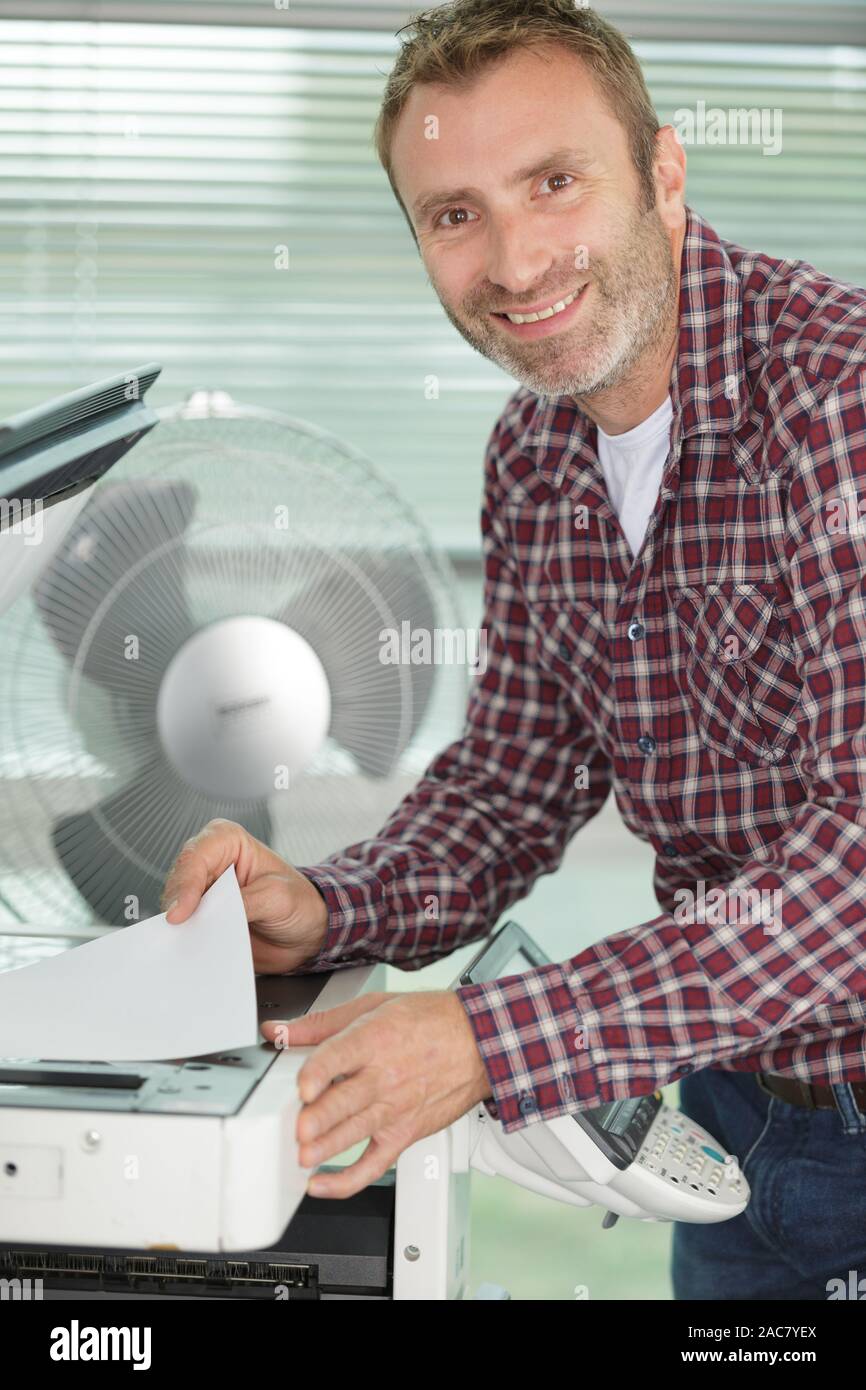 happy man is doing documents copies on copying machine Stock Photo - Alamy
