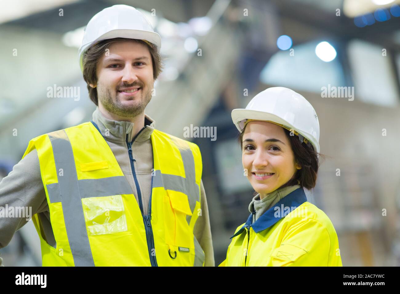 workers wearing neon jacket and hardhat Stock Photo - Alamy