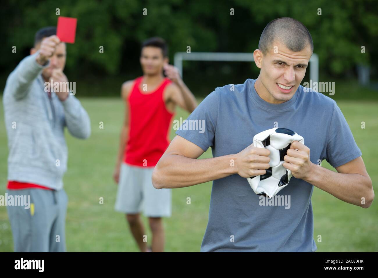 football referee showing a red card to an angry player Stock Photo - Alamy