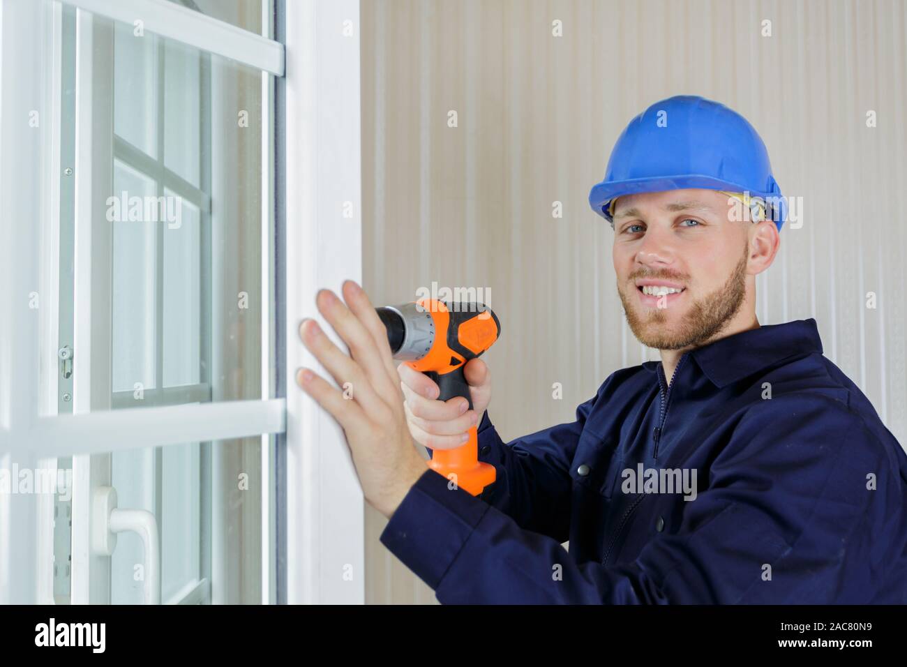man drilling window frame Stock Photo - Alamy