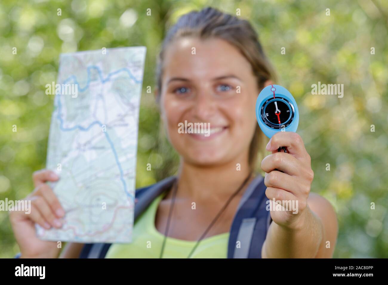 woman traveling using map and compass in nature Stock Photo - Alamy