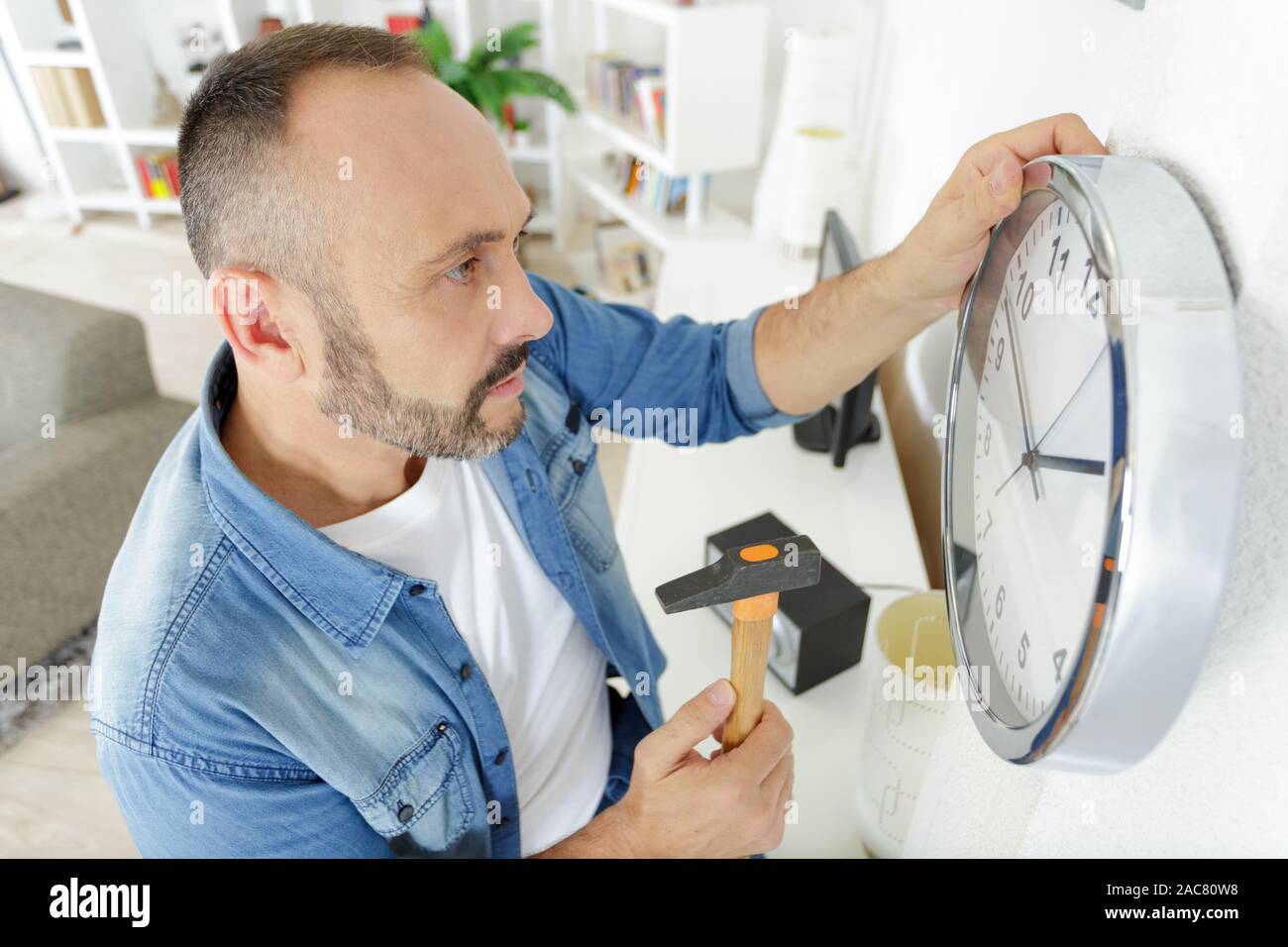 Fixing a clock hi-res stock photography and images - Alamy