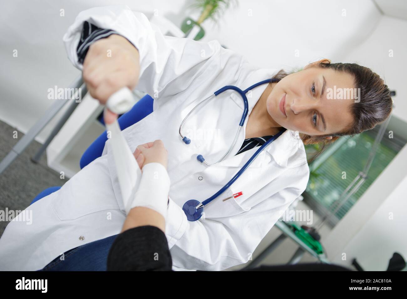 portrait of doctor bandaging a patient Stock Photo - Alamy