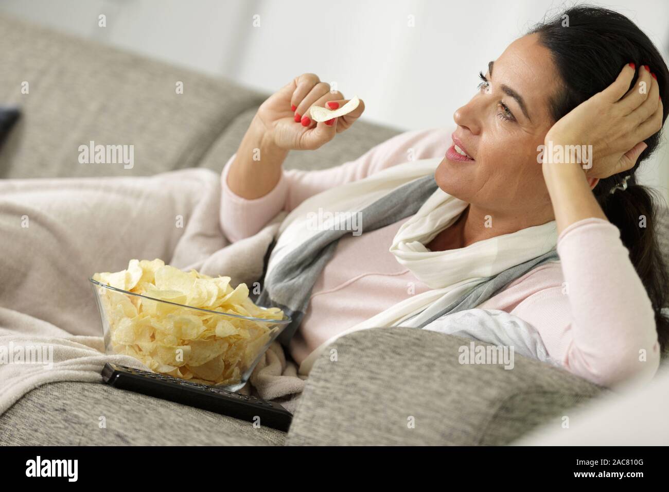 young woman spends his free time watching tv Stock Photo - Alamy