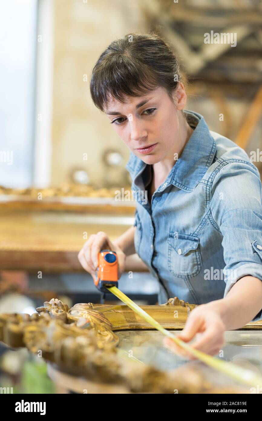 portrait of woman measuring a frame Stock Photo - Alamy