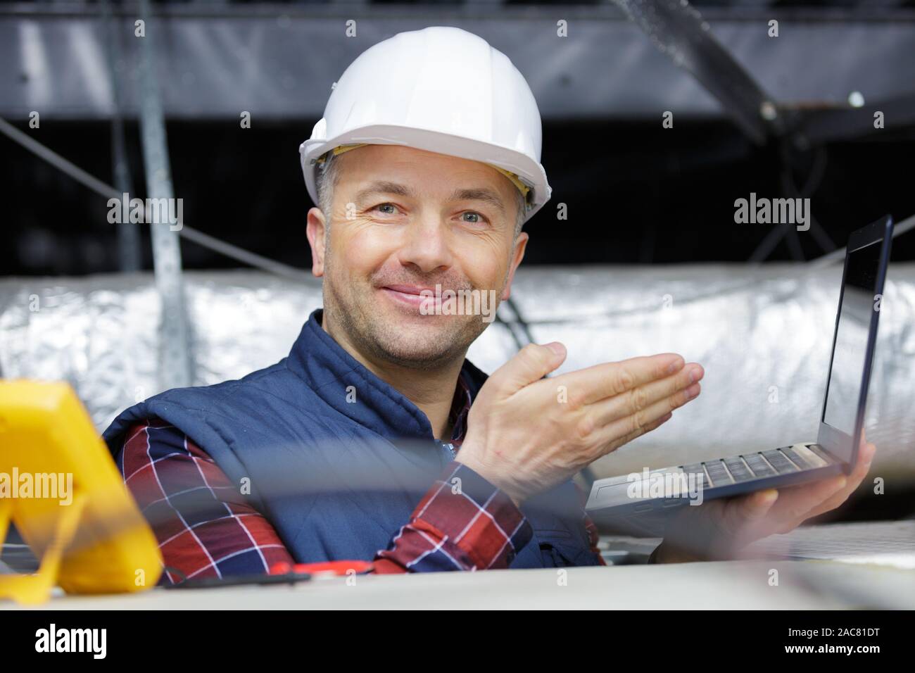 male engineer pointing a pc at building construction site Stock Photo ...