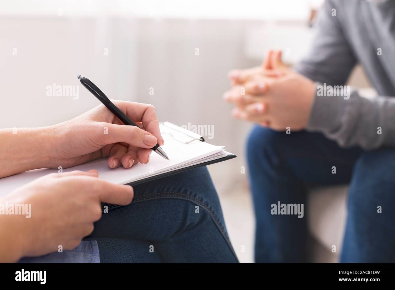 Therapist noting patient speech during personal session Stock Photo - Alamy