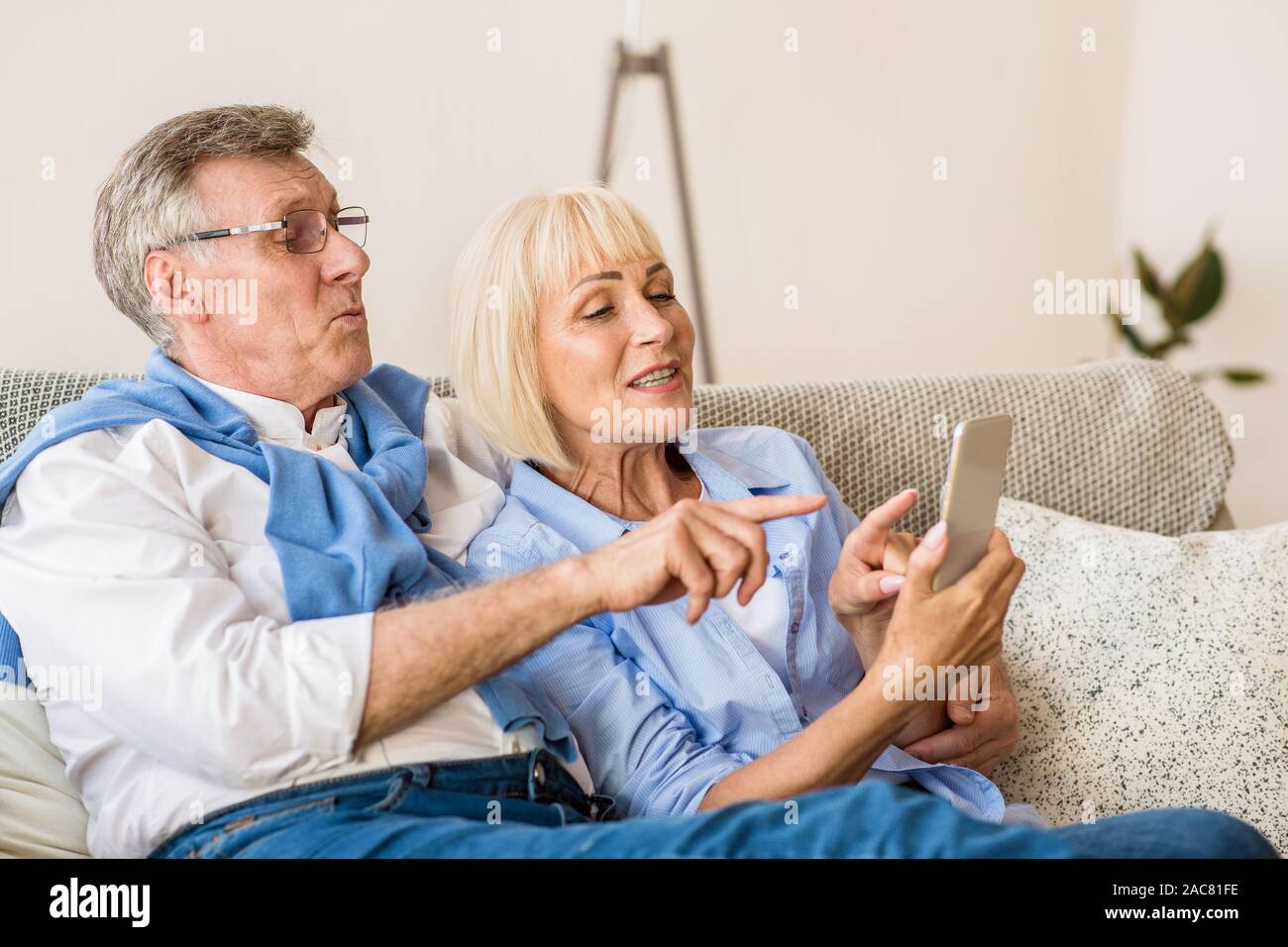 Modern senior couple making video call on cellphone Stock Photo - Alamy