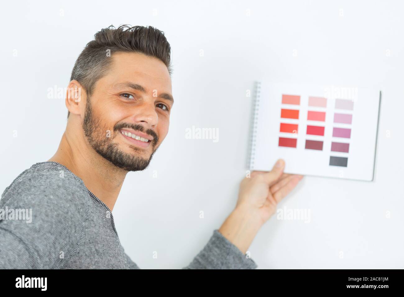 worker holding samples for choosing color of wall Stock Photo - Alamy