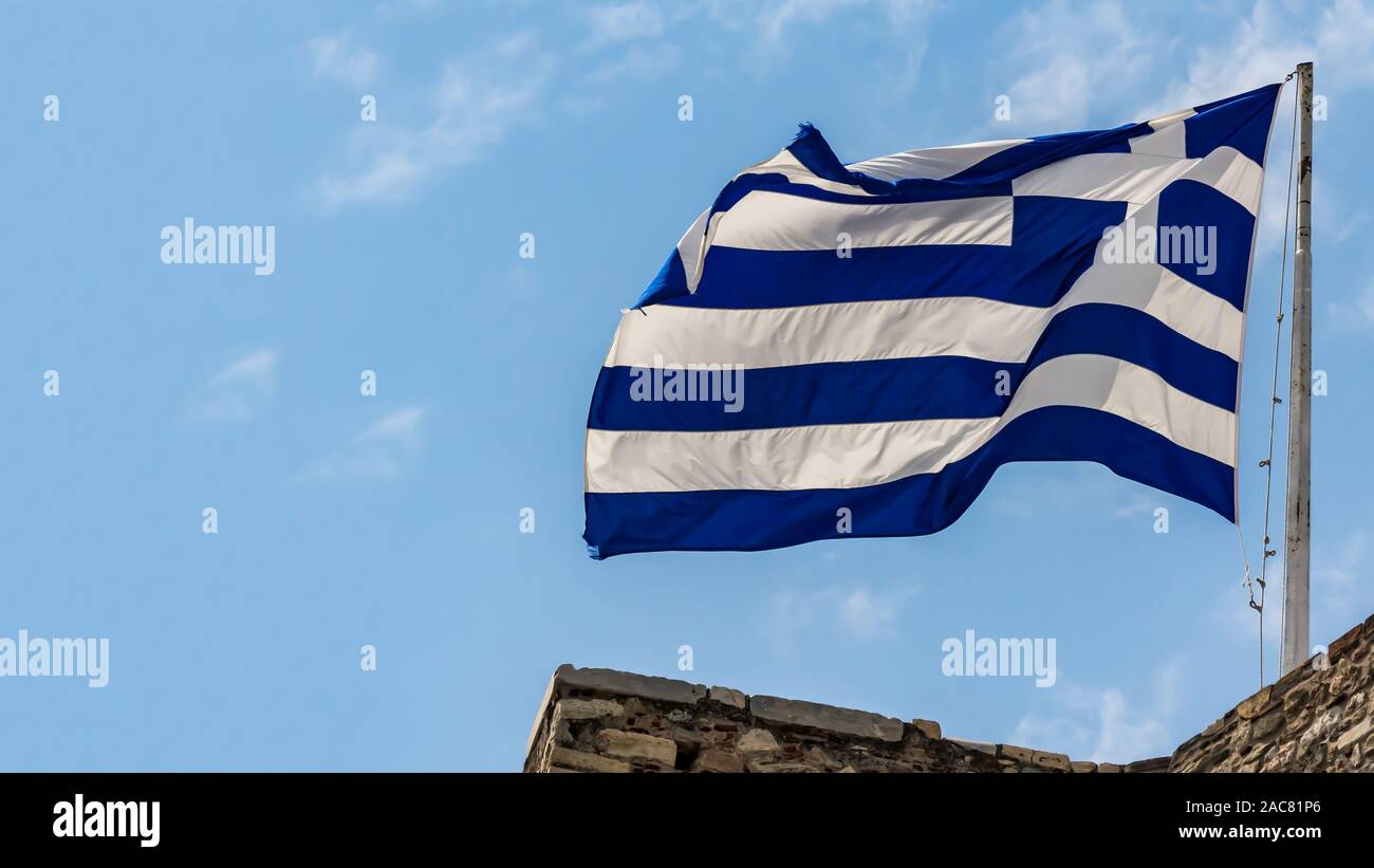 Greek national flag waving on blue sky background. Hellenic Republic ...