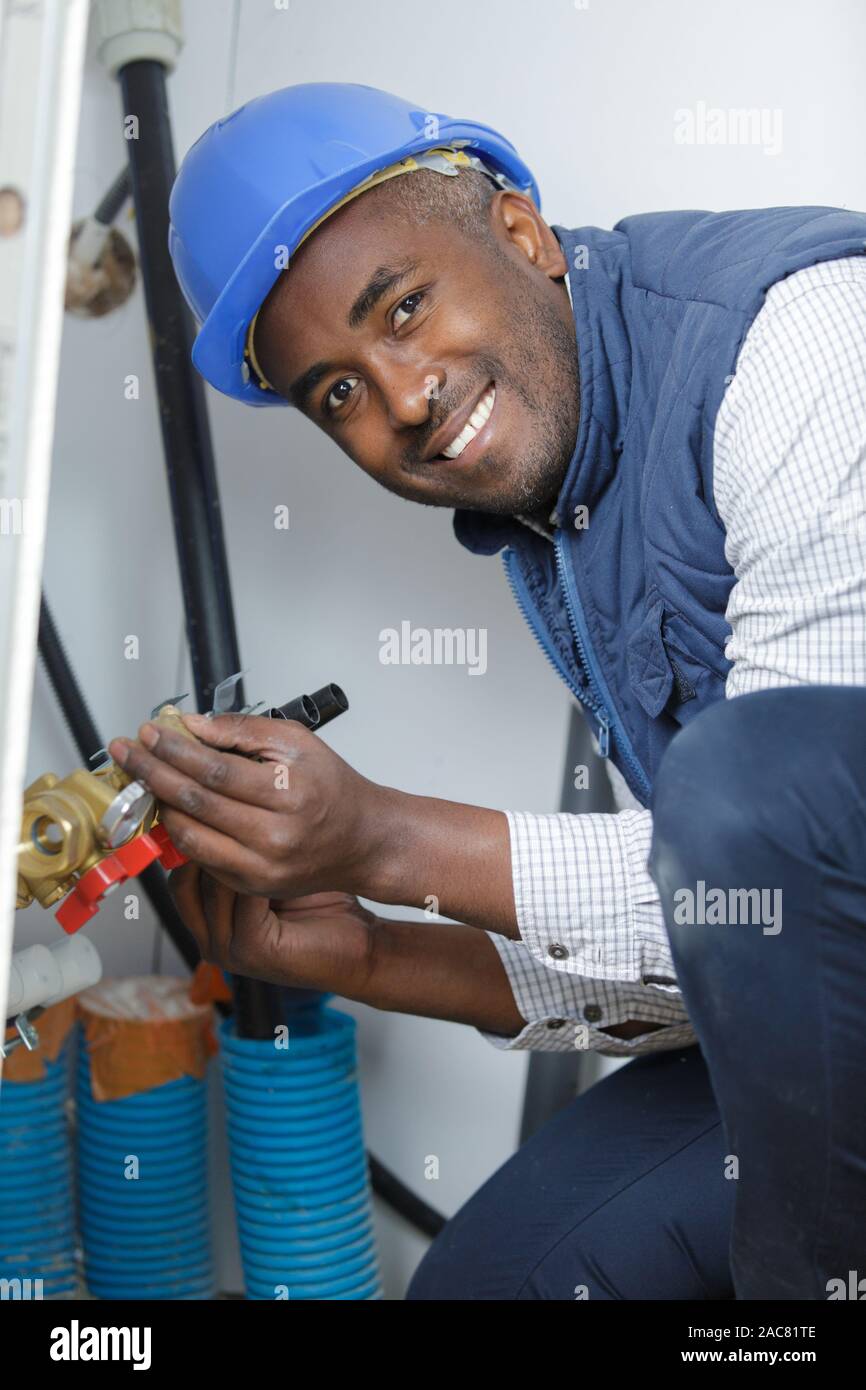 worker installing pipings on a construction site Stock Photo - Alamy