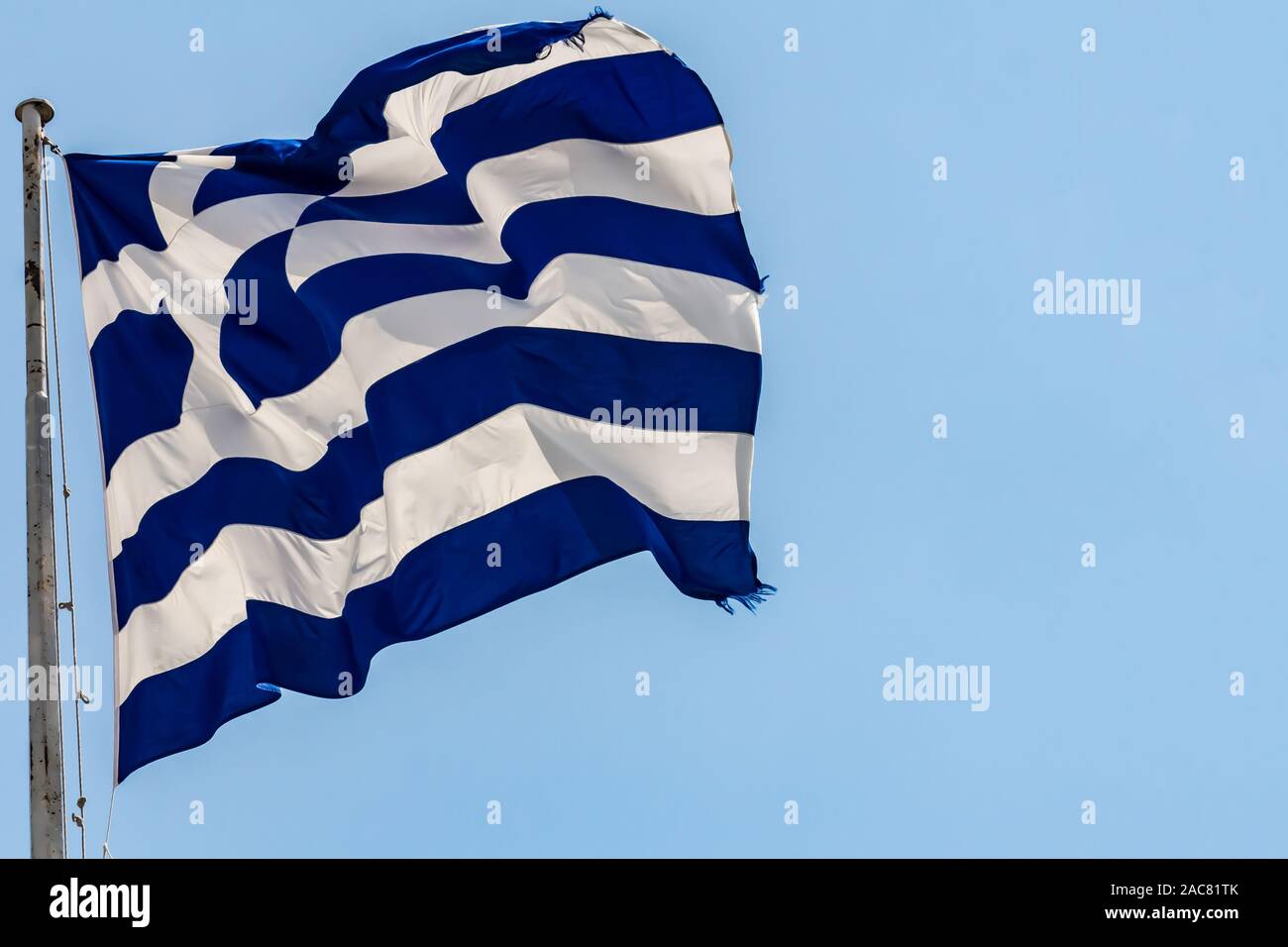 Greek national flag waving on blue sky background. Hellenic Republic ...