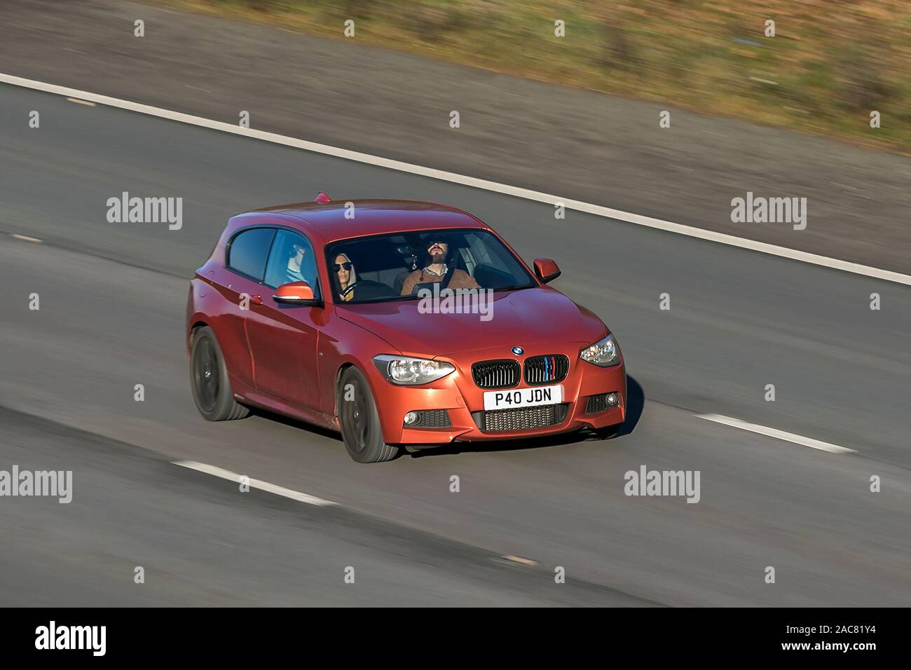 Blurred moving car P40JDN BMW 125I M Sport traveling at speed on the ...