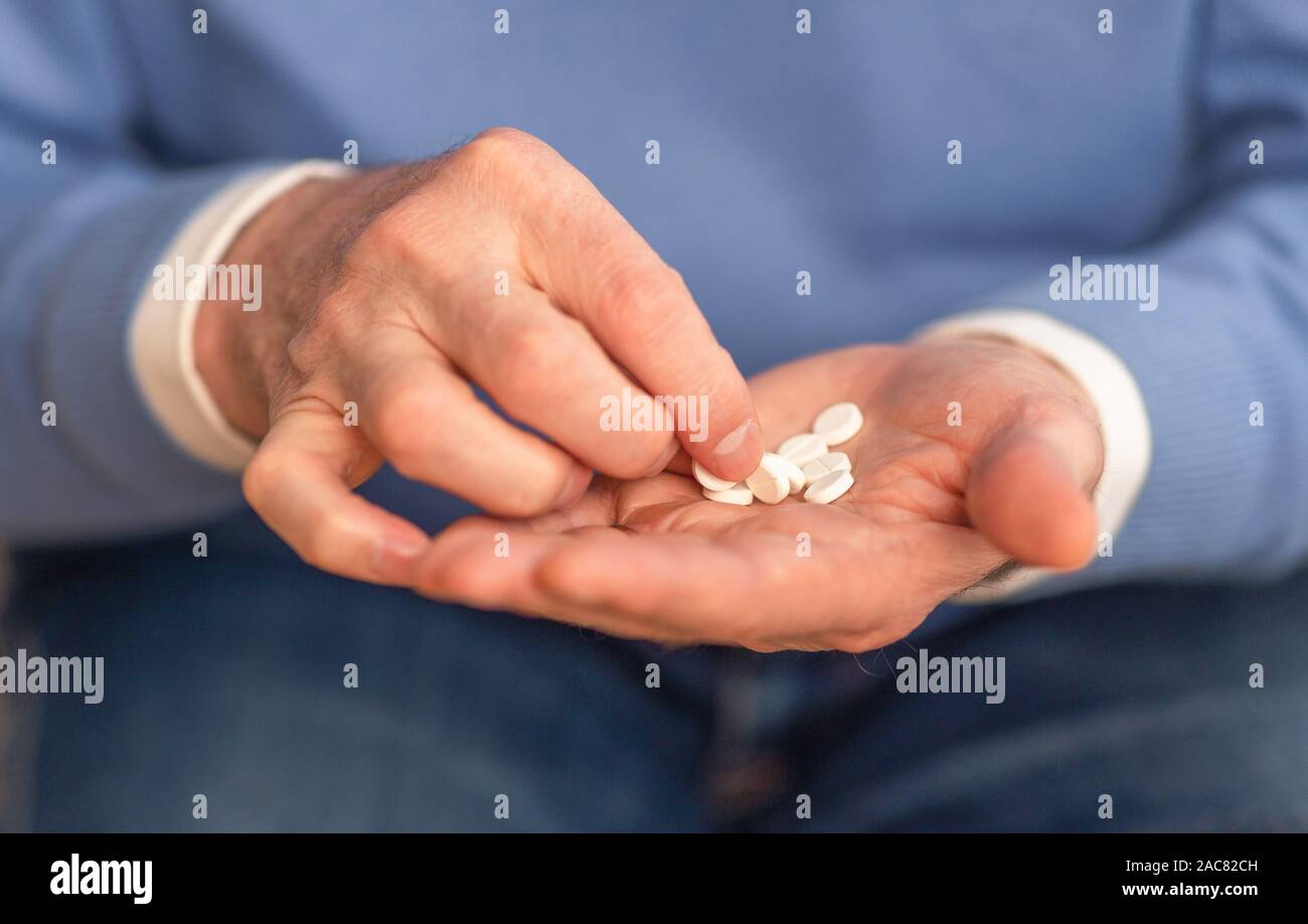 Elderly Man's Hands Picking A Pill From Handful Of Tablets Stock Photo ...