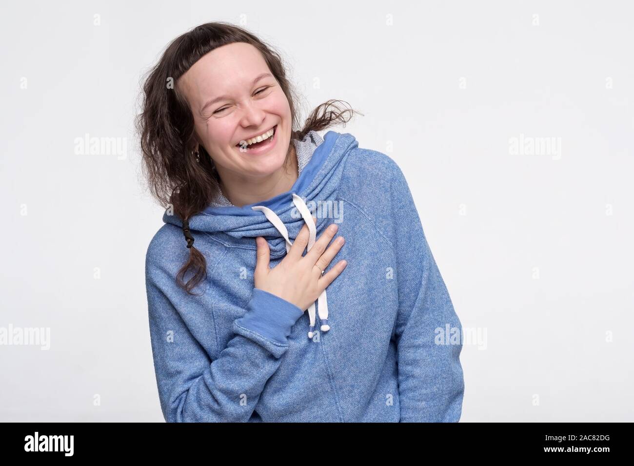 Caucasian confident woman in blue clothws smiling standing with folded ...