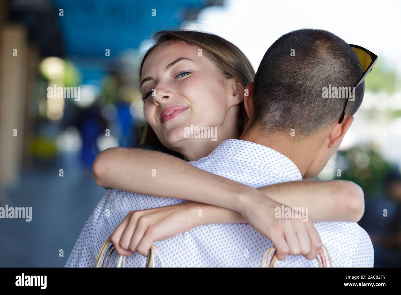 Young man embracing teenage hi-res stock photography and images - Alamy