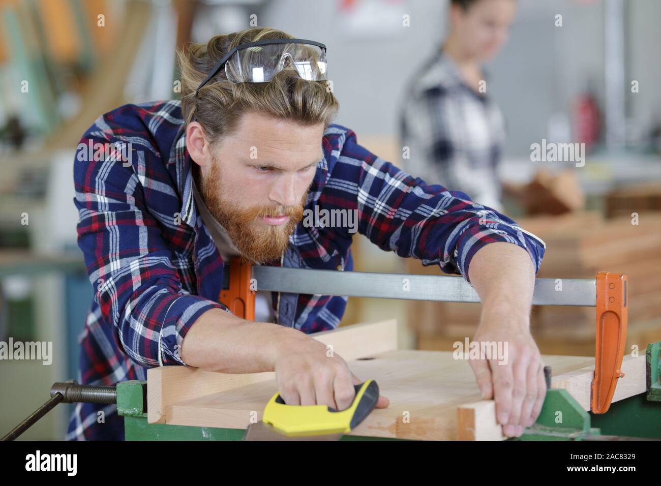 a man uses a hacksaw while wood sawing Stock Photo - Alamy