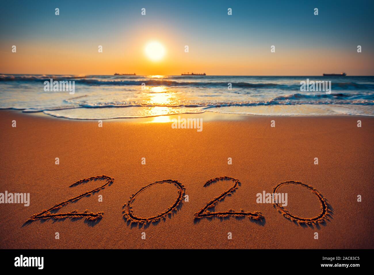 Happy New Year 2020 concept, lettering on the beach. Sea sunrise Stock ...