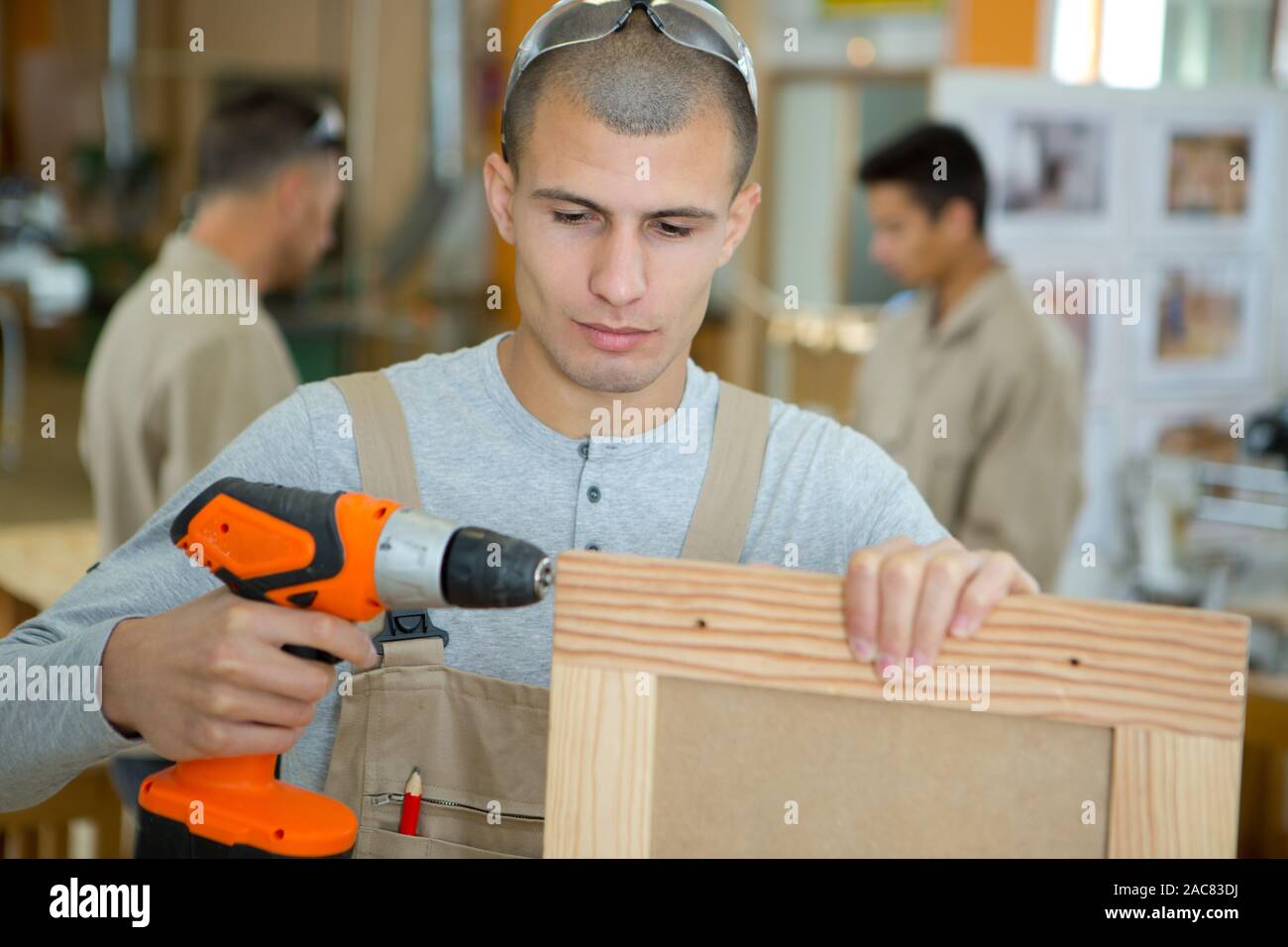 woodworking apprentice assembling wood frame Stock Photo - Alamy