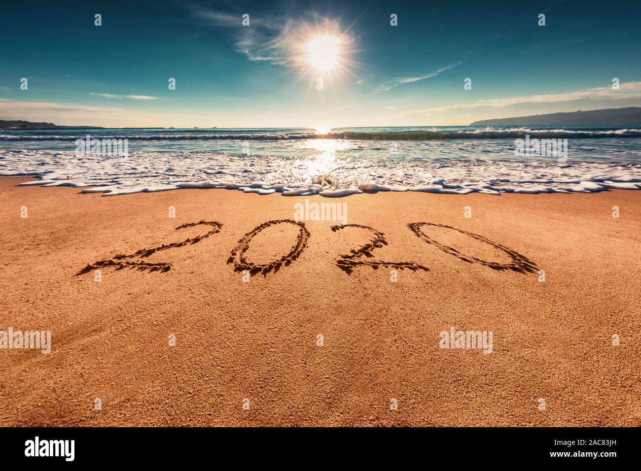 Happy New Year 2020 concept, lettering on the beach. Sea sunrise Stock ...