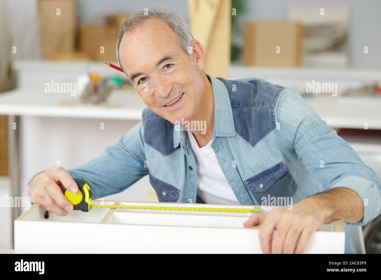 Senior craftsman measuring wood hi-res stock photography and images - Alamy