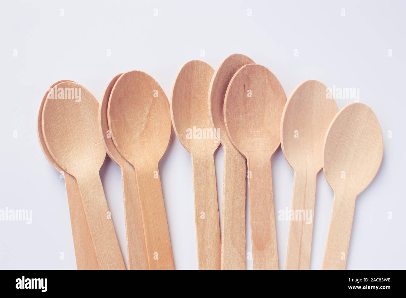 Large number of wooden spoons laid on a white background Stock Photo ...